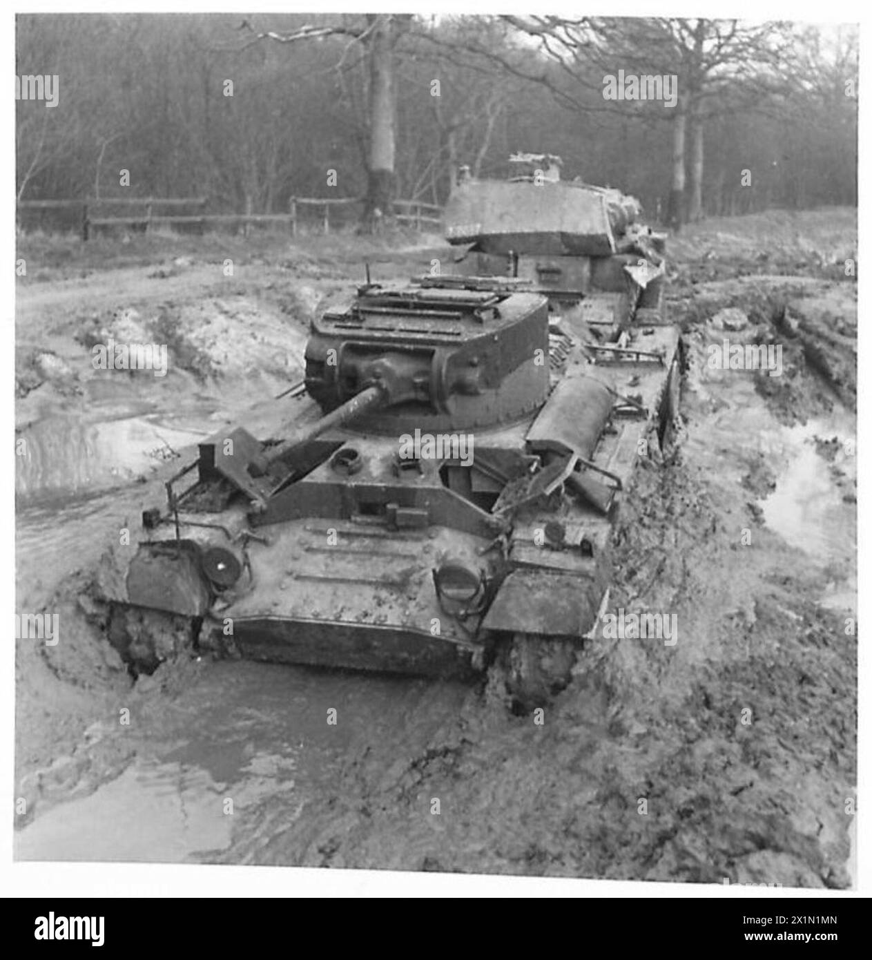 A Valentine tank tows a Cruiser Mk. IV through deep mud during testing ...