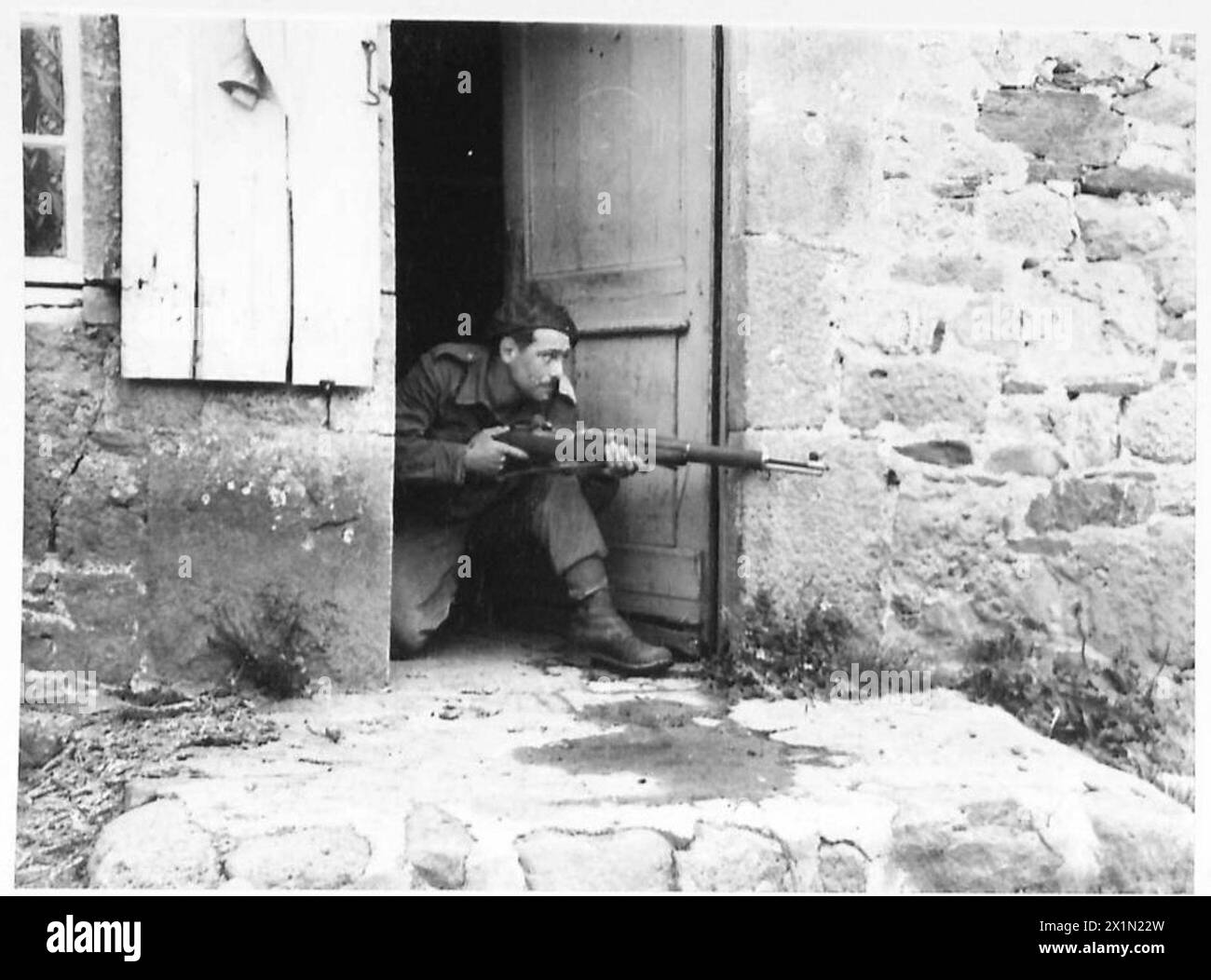 French commandos practice using cover in a farmyard environment as part ...