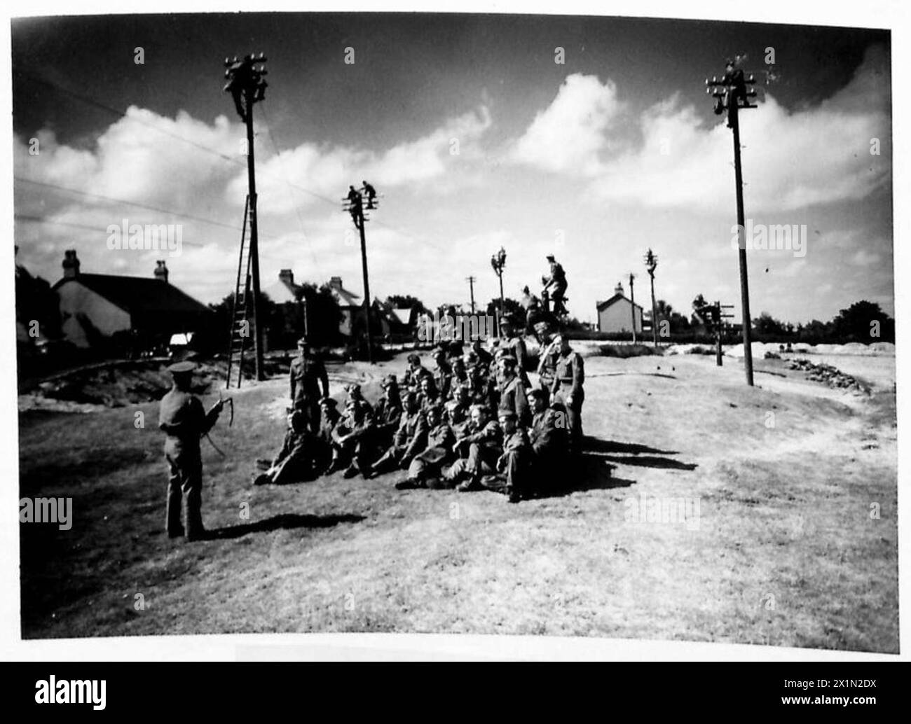 A general view of a British Army signal training field shows poles ...