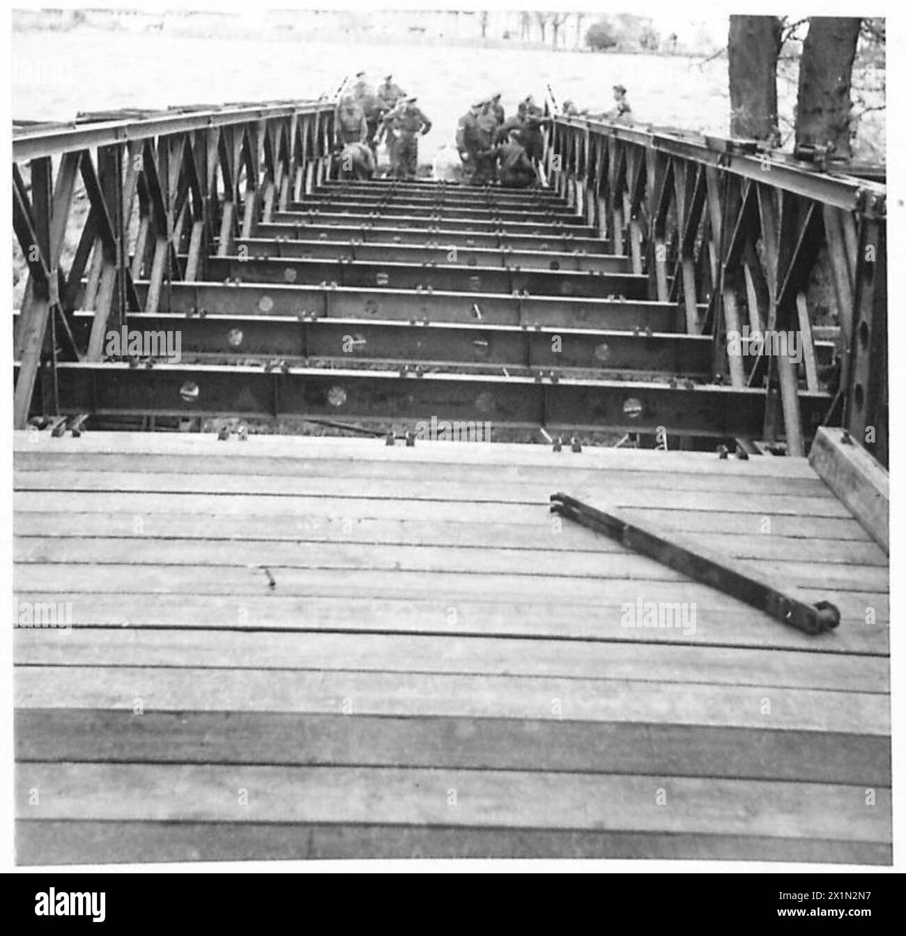 The British Army removes guides from the last half of a Bailey bridge ...