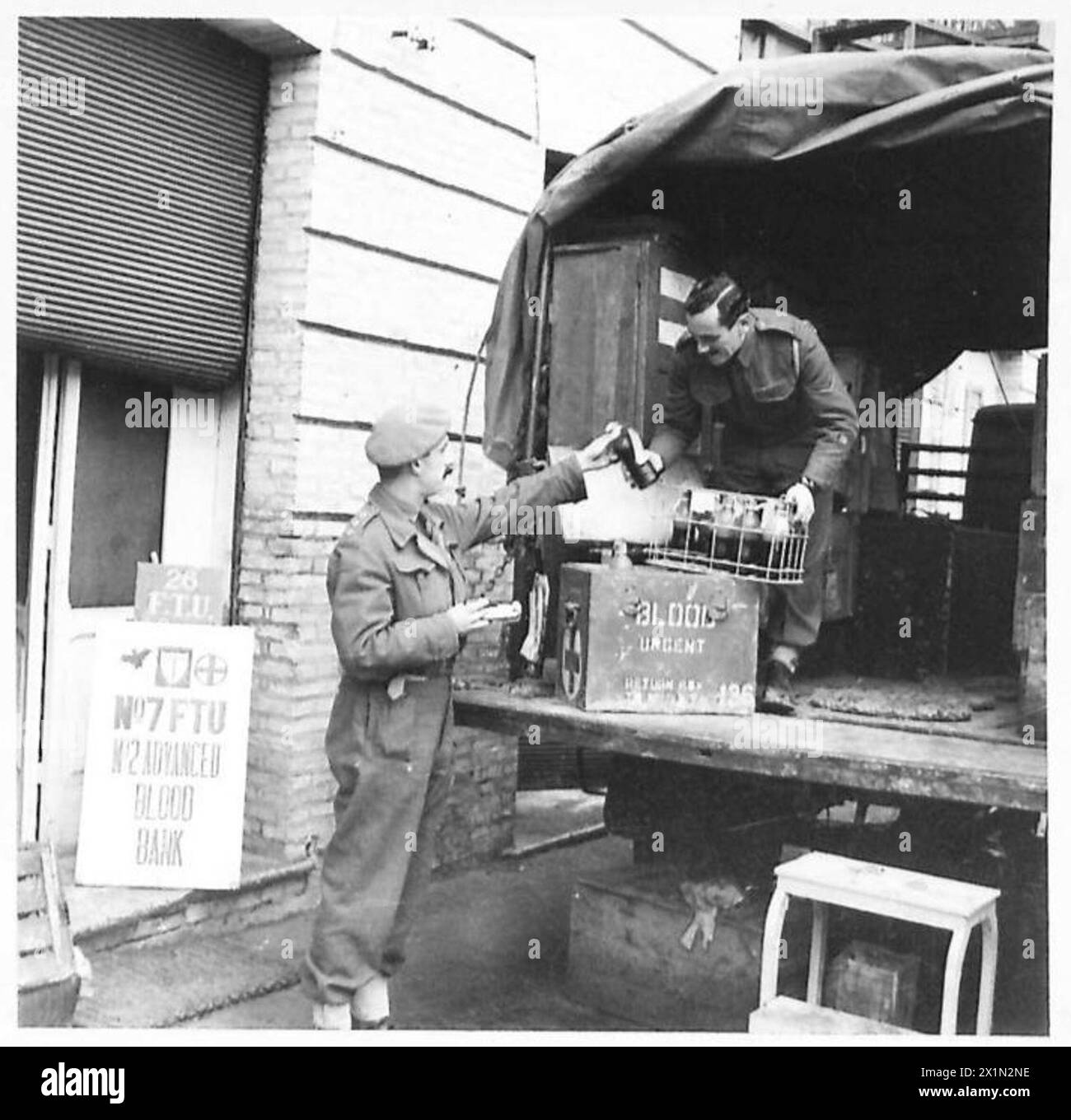 Captain M.G. Sutton and Lance Corporal J.H. Watson of the RAMC check a ...