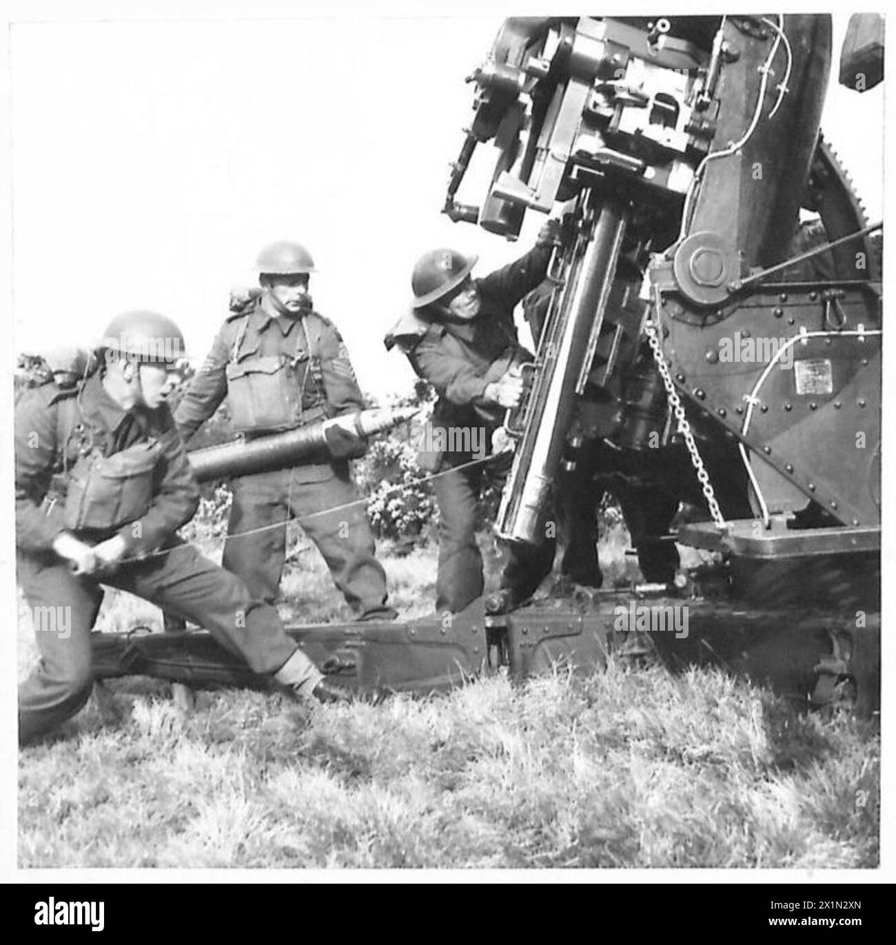 British Army anti-aircraft gunners practice loading and operating guns ...