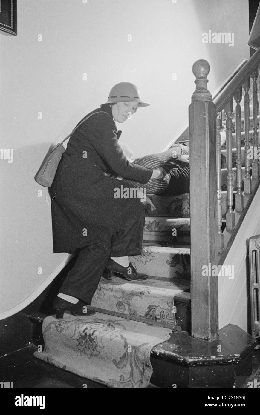 A woman firefighter in Civil Defence practices dragging a body down ...