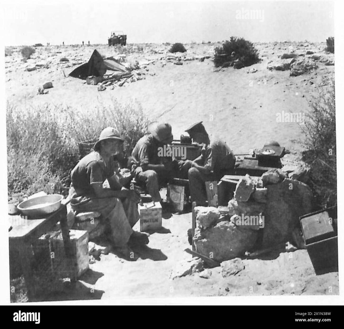 Cooks of the British Army prepare meals in their desert kitchen during ...