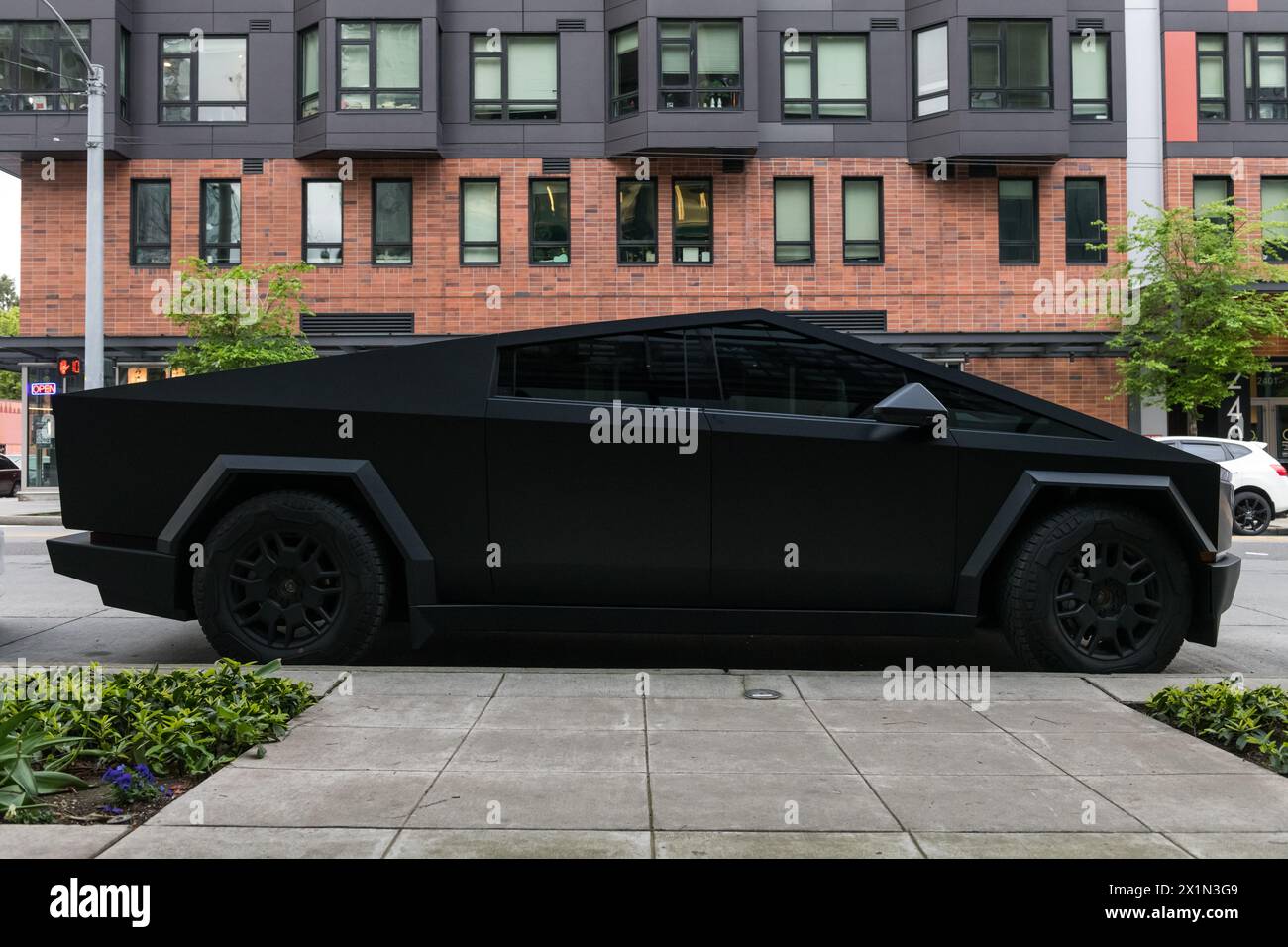 Seattle, USA. 15 Apr, 2024. A parked matte black wrapped Tesla ...