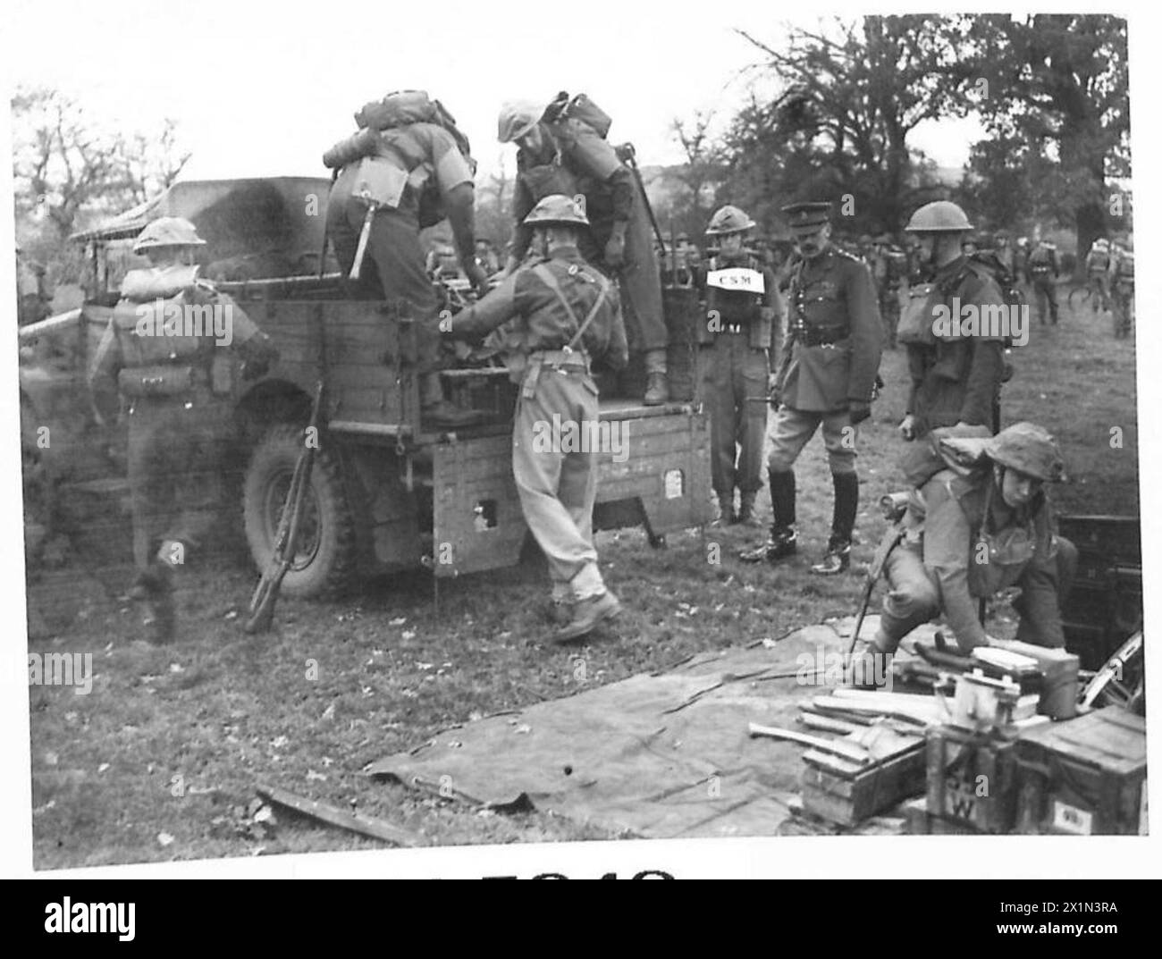 Trucks are loaded while guards are on parade, with men labeled for a ...