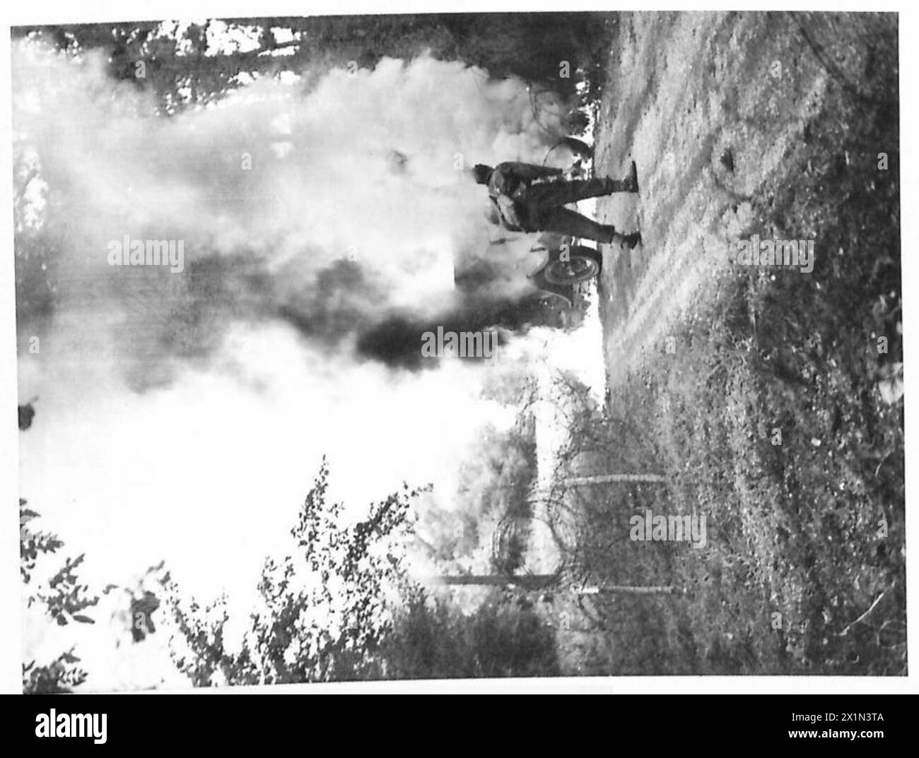 A British Army armoured vehicle stops after being set on fire by a ...