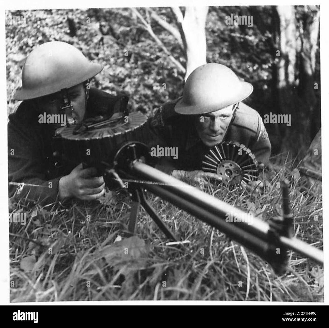 Regimental Sergeant Major Roberts operates a Lewis gun with Pte. Ismay ...