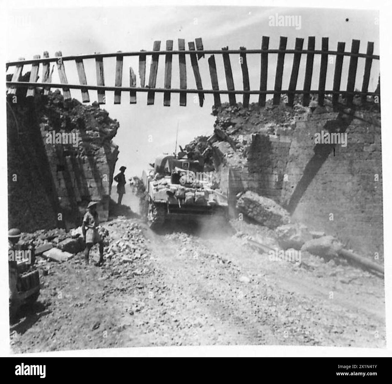 A tank of the 6th South African Armoured Division advances through a ...