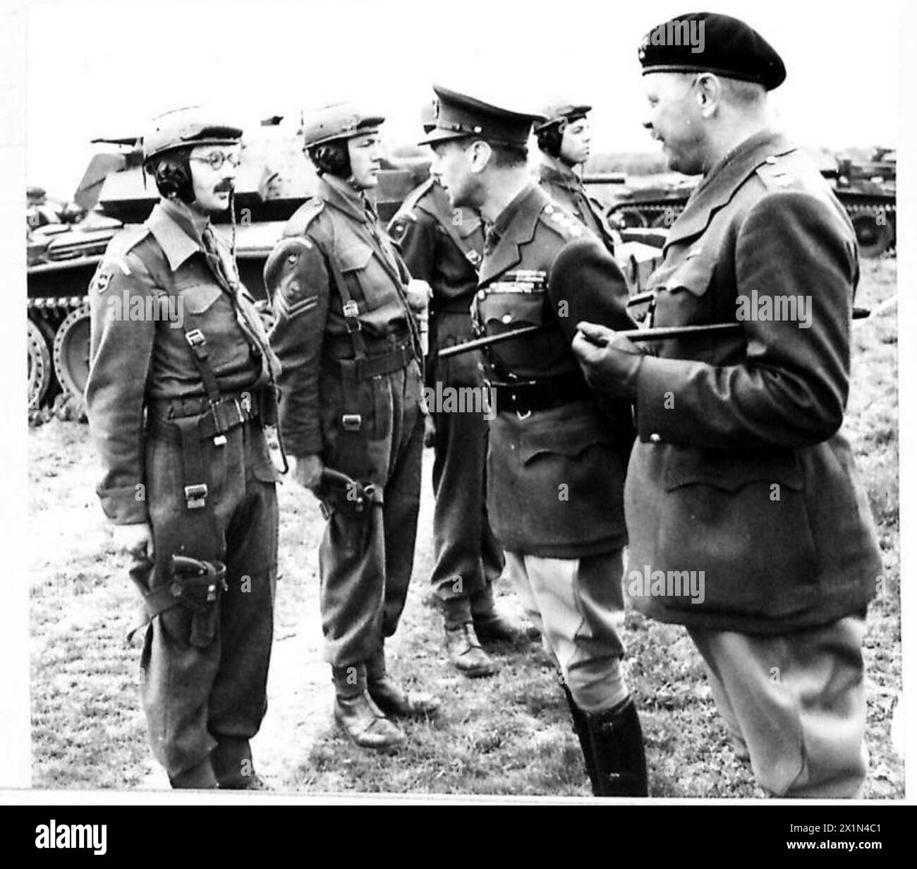 The King speaks with an officer while inspecting tanks and personnel in ...