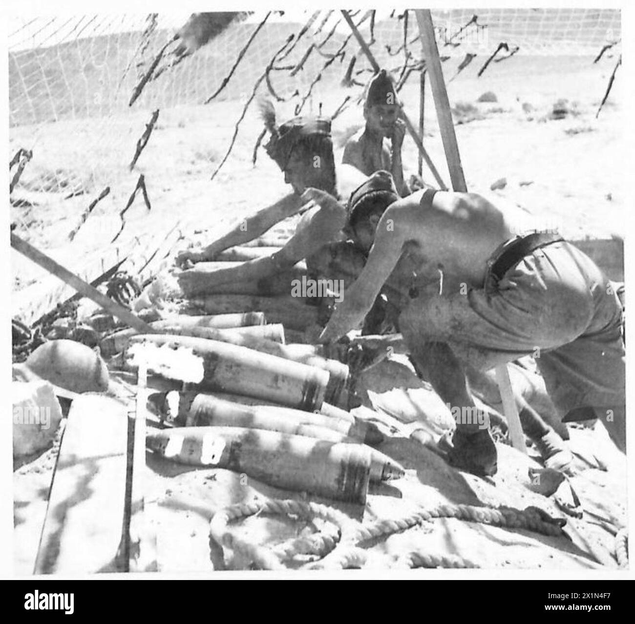 Gunners in the Western Desert preparing and fusing artillery shells ...