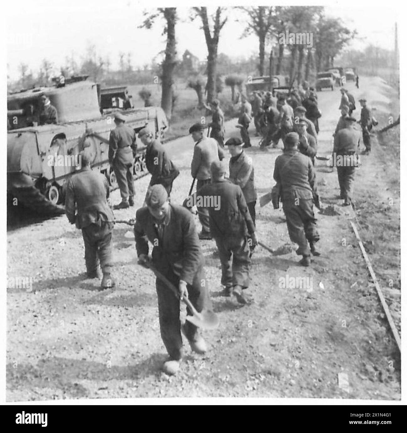 Russian displaced persons in a camp assisted in road work near passing ...