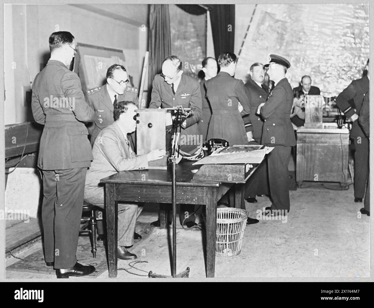 The Brazilian Air Minister inspects stereoscopic photographs of damage ...