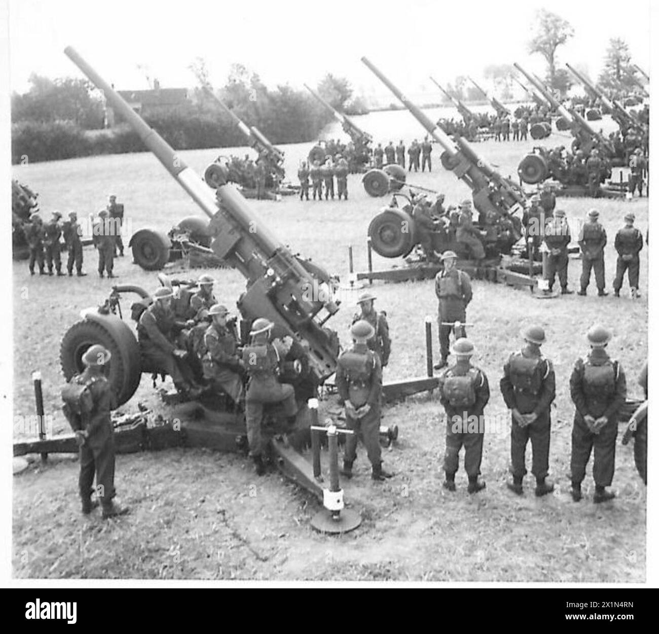 A.A.MOBILE REGIMENT - A.A. guns and crews with lorries in background ...