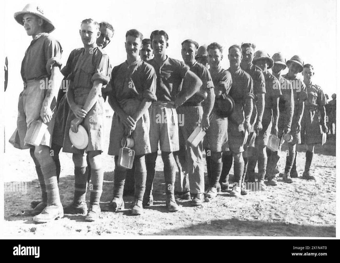 Infantry soldiers line up for the mid-day meal during training, British ...