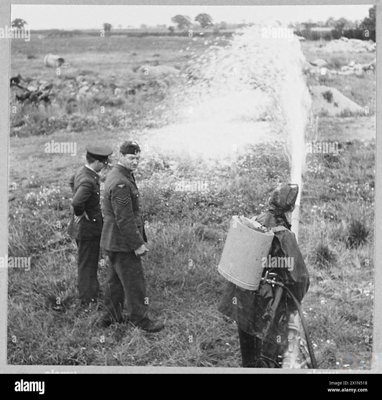 A fire crew member tests a knapsack foam branch pipe at an RAF station ...