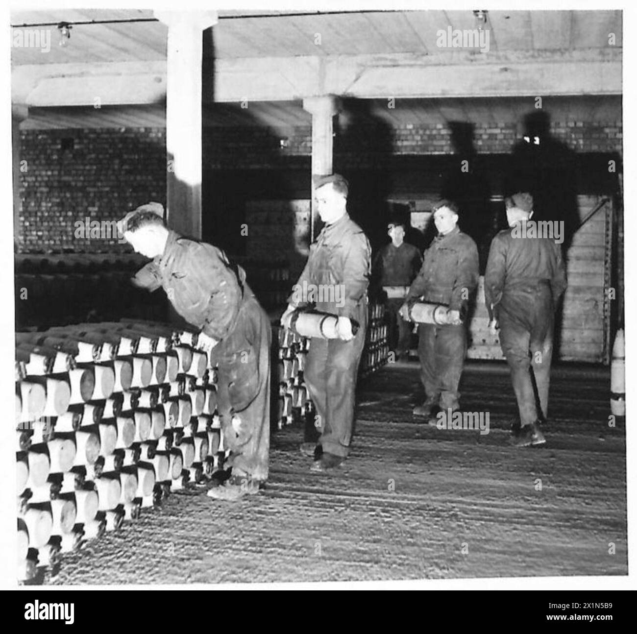 RAOC personnel unload 5.5-inch Howitzer shells from trucks into depot ...