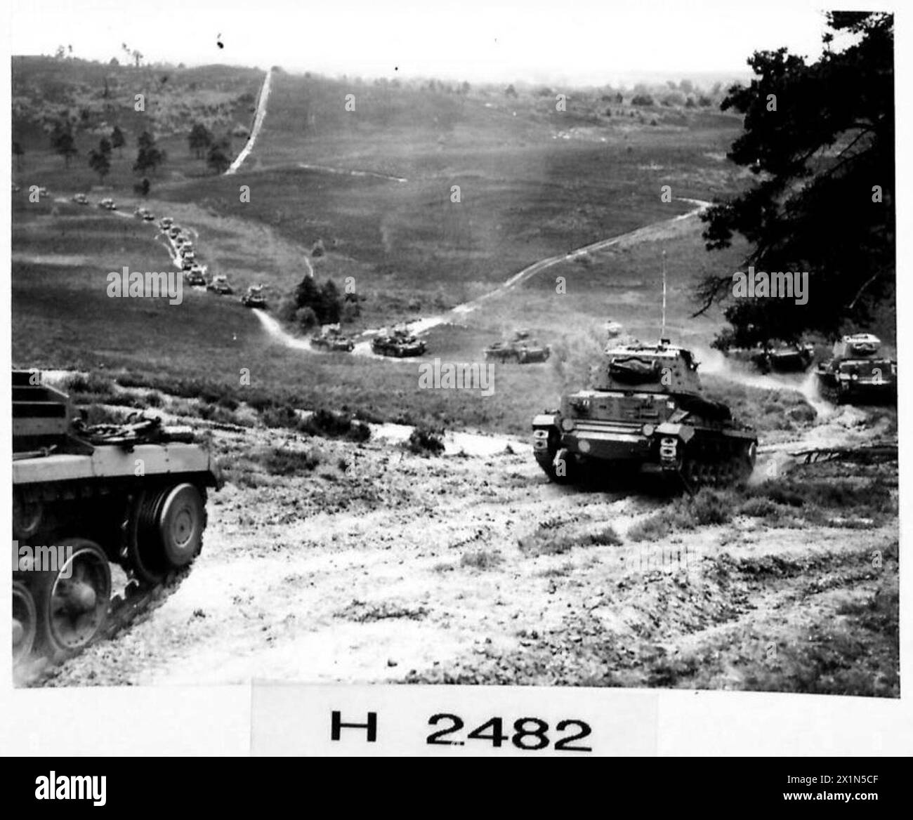 Royal Tank Regiment tanks maneuver across a common during a military ...