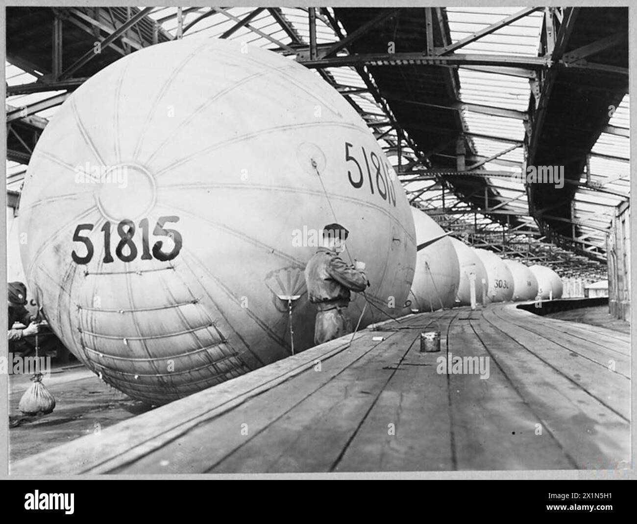 INFLATION SHEDS AT A NAVAL BALLOON DEPOT - 9531 A line up of balloons ...