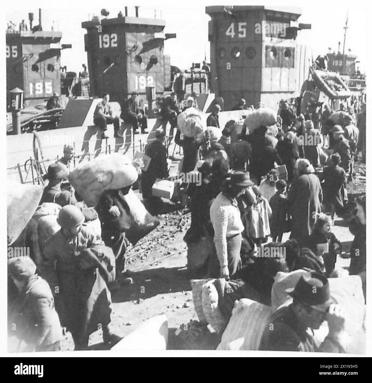 Evacuation of refugees from Anzio shows crowded dockside with L.C.I ...