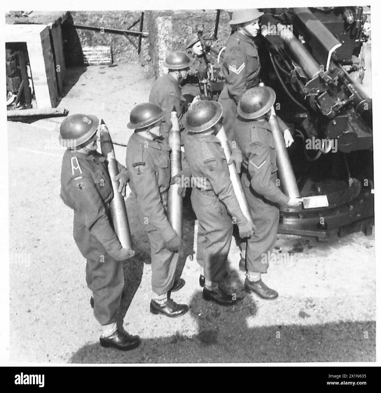 Polish and British gunners of the 71st Anti-Aircraft Brigade load ...