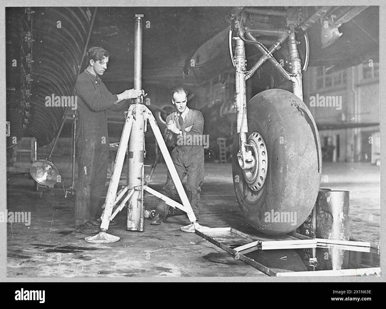 MEN BEHIND THE MACHINES - [1415] Jacking up the port wheel to repair ...