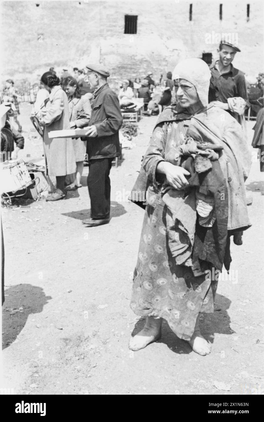 An impoverished barefoot Jewish woman is seen in a street market in the ...