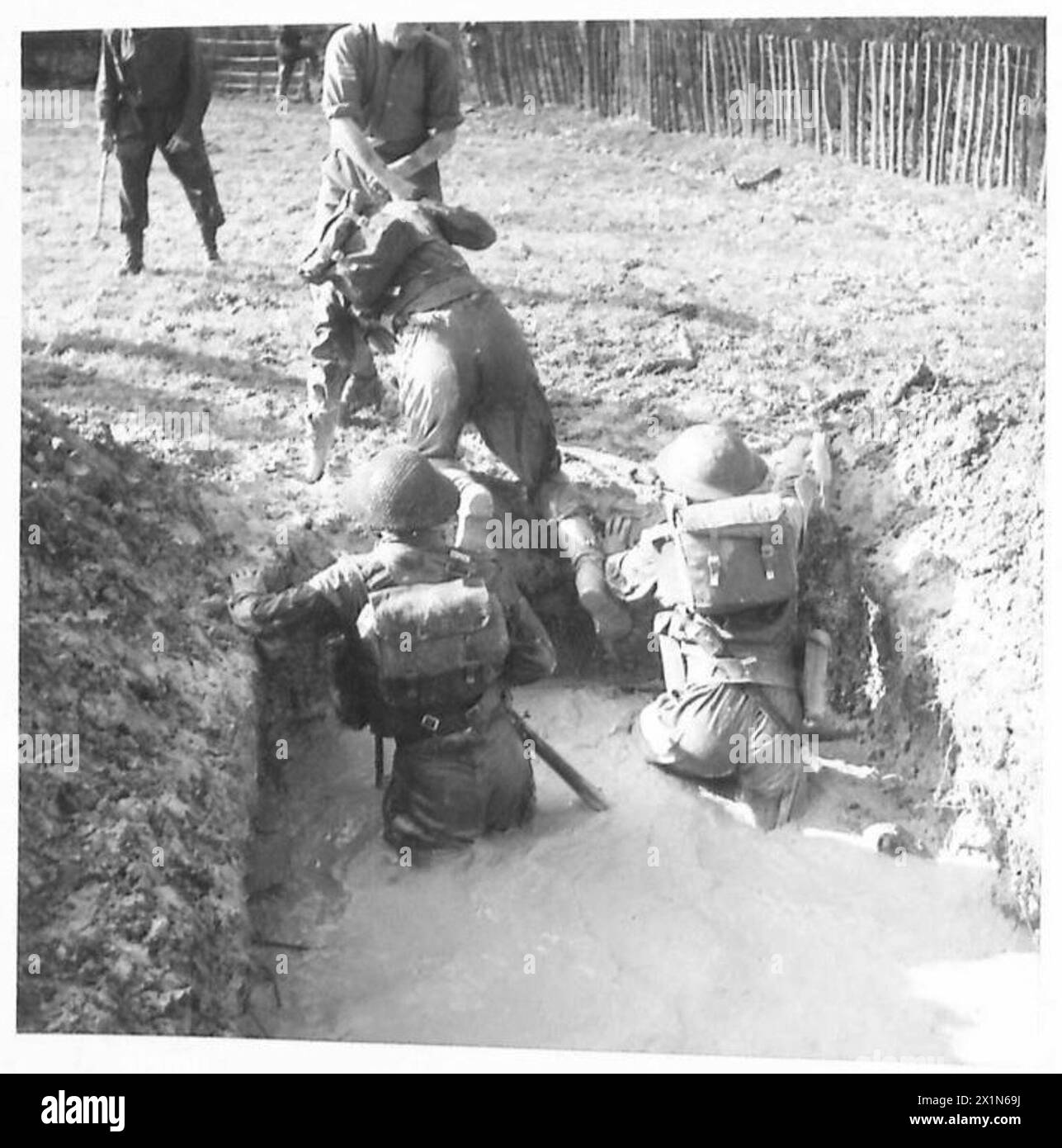 STRENUOUS TRAINING AT BATTLE SCHOOL - Men emerging from a mud bath ...
