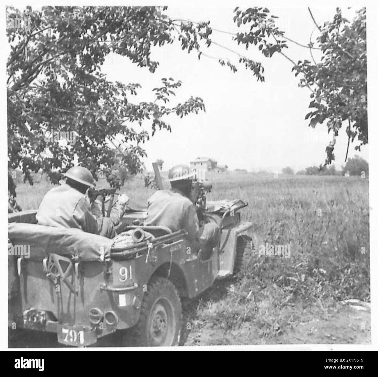A machine gun is mounted on a jeep under a tree near Pontecorvo during ...