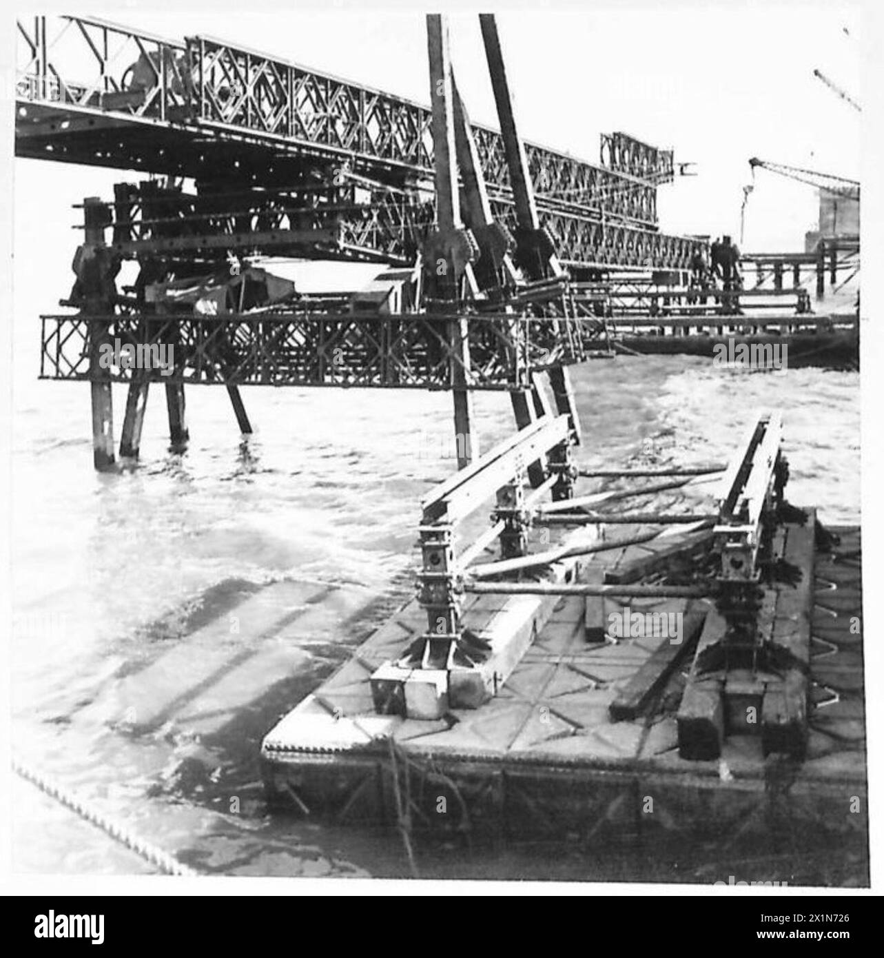 Photographs show a large raft and 'V' trestling pier in use during ...