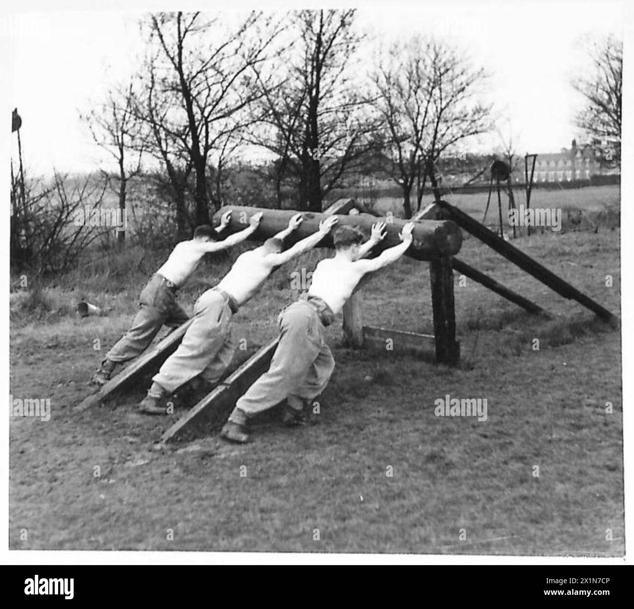 Series of photographs showing British Army physical training exercises involving pulling ...
