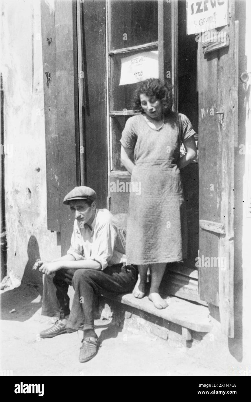 Shoemaker J. Grynblat and a female family member stand on the doorstep ...
