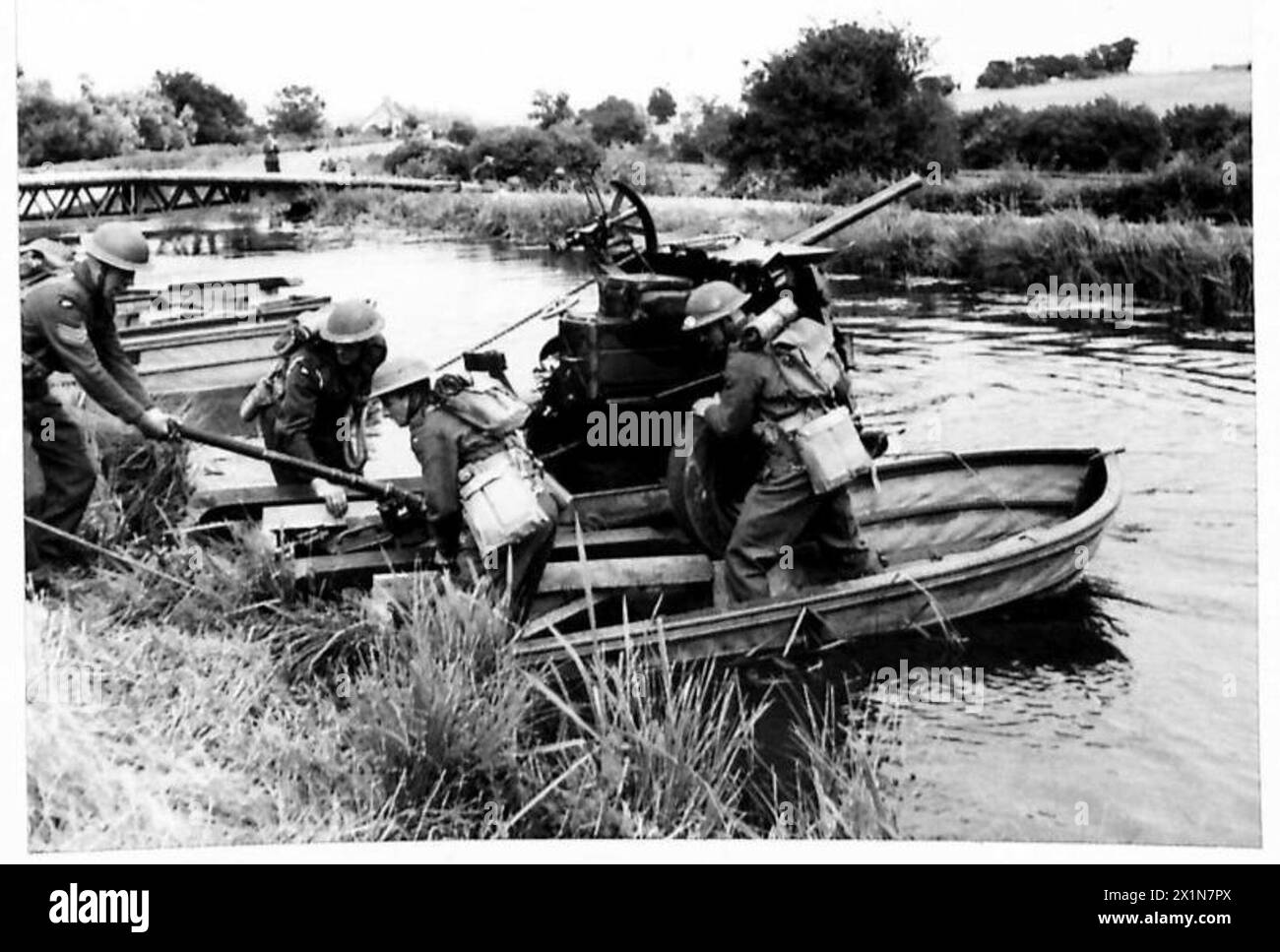 BRIDGING DEMONSTRATION - Troops taking an anti-tank gun across a river ...