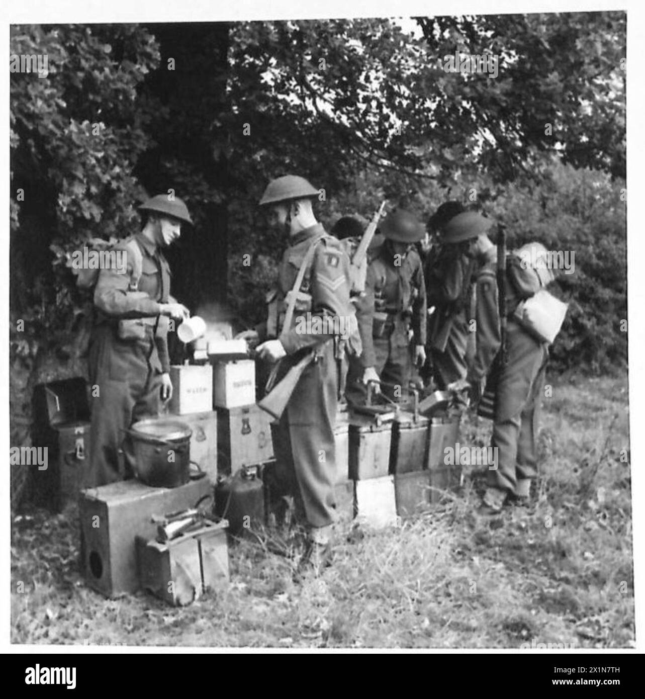 Scots Guards soldiers receive meals in mess-tins from Army cooks at a ...