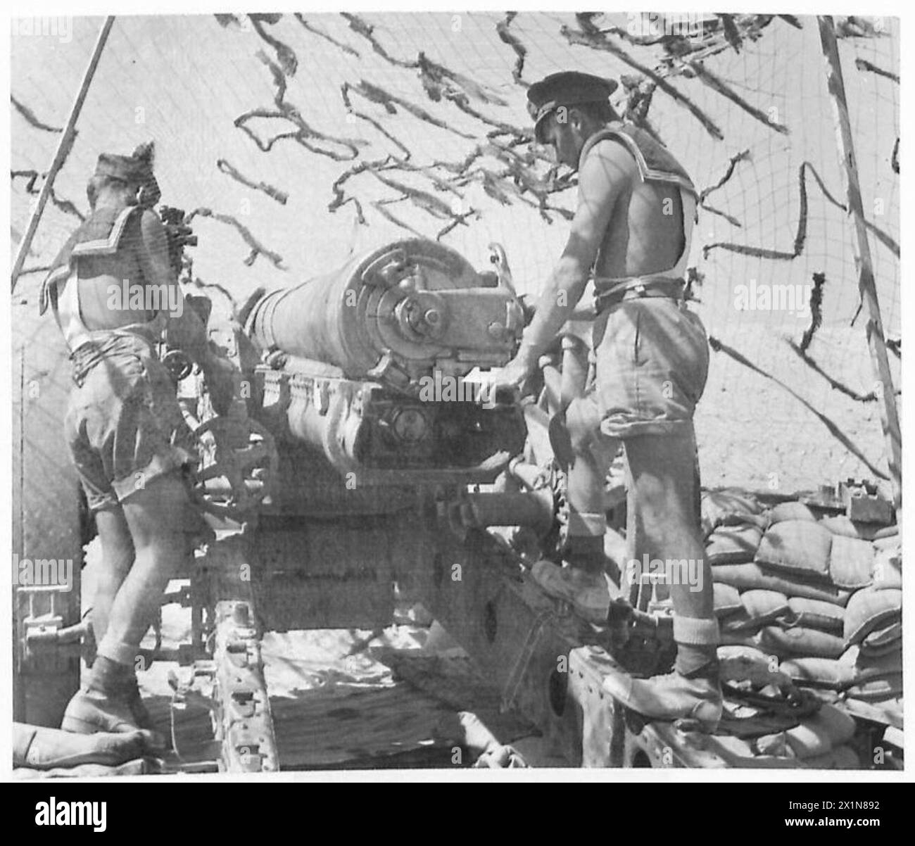 OFFICIAL PHOTOGRAPHS TAKEN IN THE WESTERN DESERT - Gunners wearing souvenirs of their visits to ...