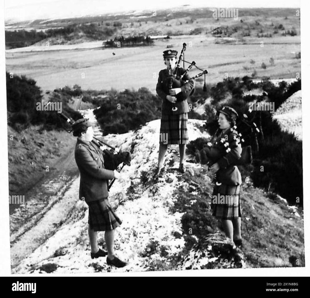 At a Scottish ATS training centre, three ATS members play bagpipes ...