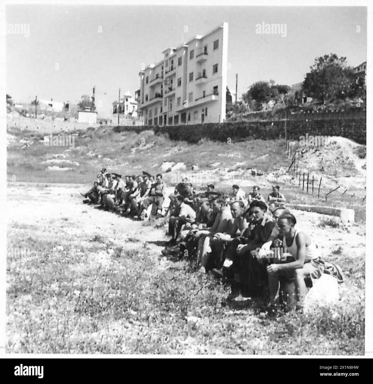 Off-duty gun crews of a British coast battery in Lebanon watch a ...
