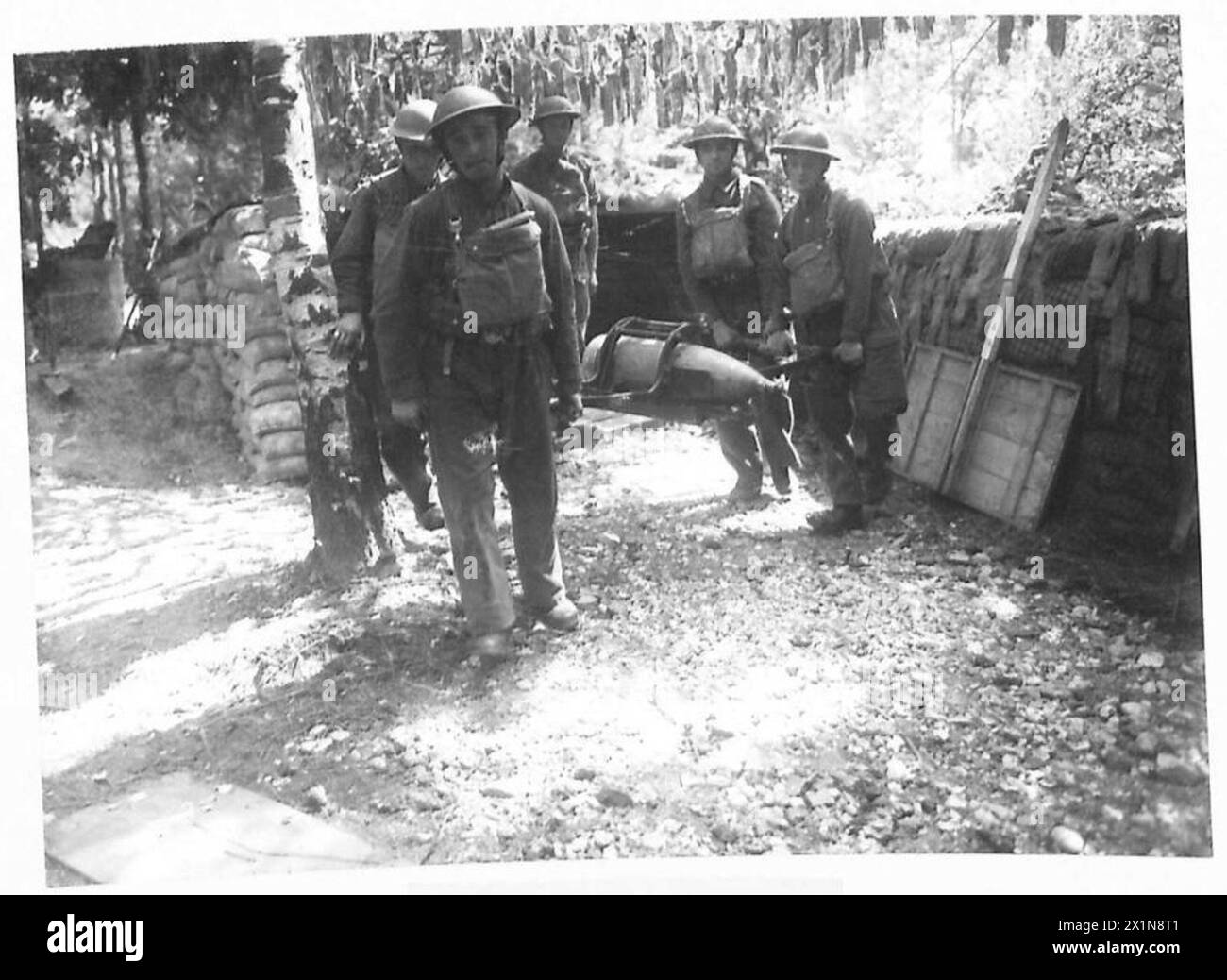 PREPARING A WARM RECEPTION - Carrying a 270 lb. shell to the gun ...