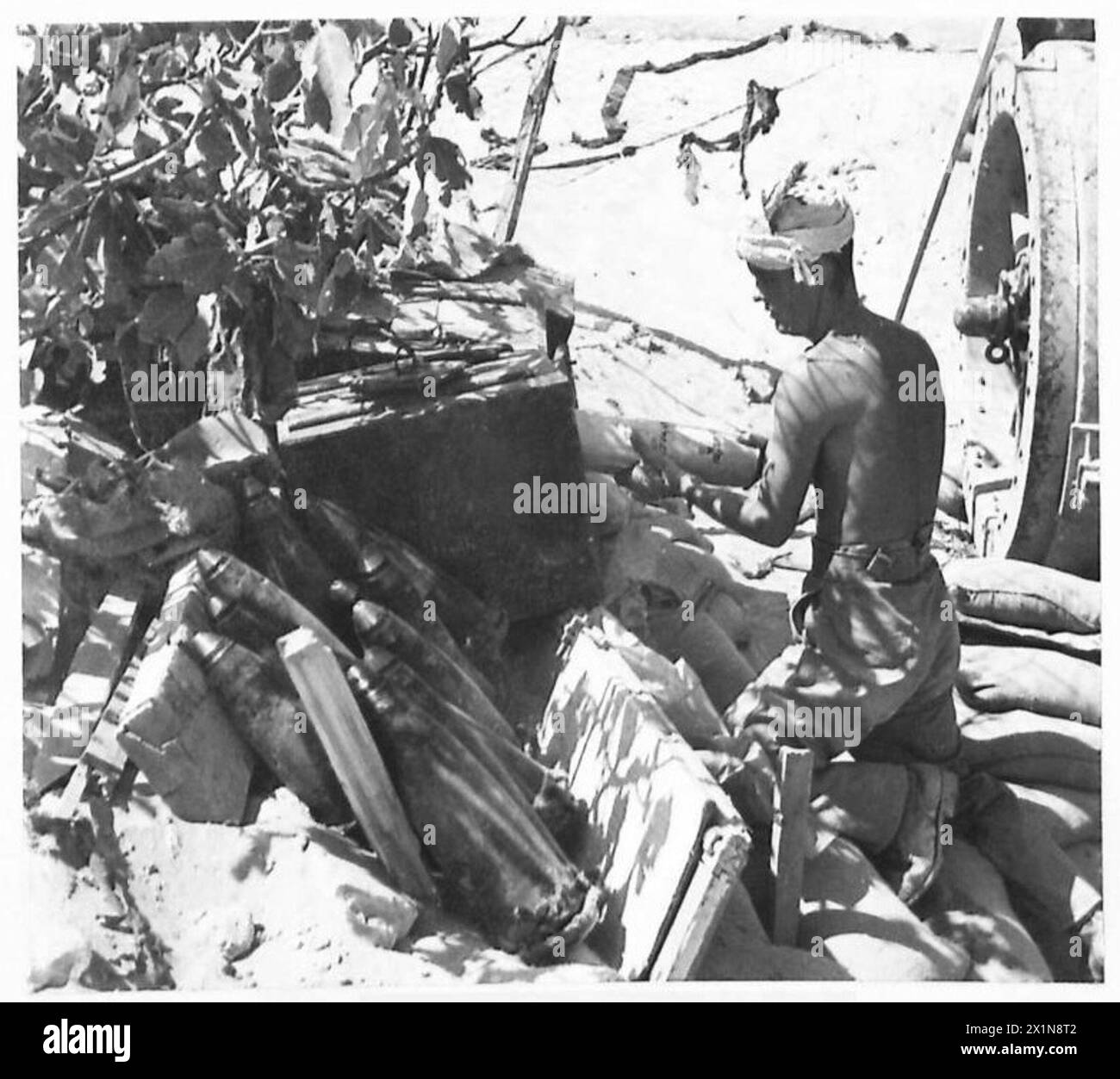 OFFICIAL PHOTOGRAPHS TAKEN IN THE WESTERN DESERT - A shell dump in a ...