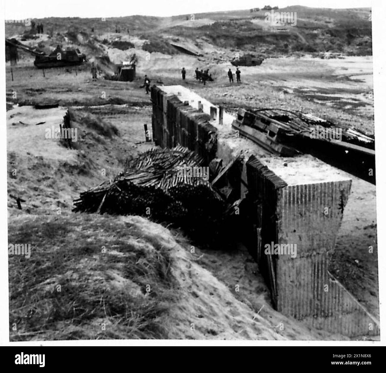 Photographs show a bridge and fascine positioned on an anti-tank wall ...