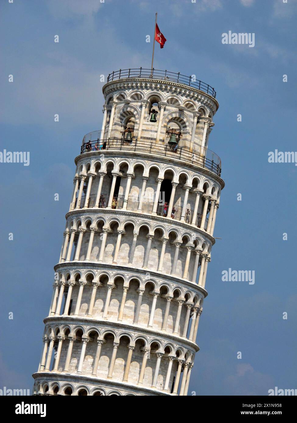 Detail of the top of the Leaning Tower of Pisa isolated in the blue sky ...