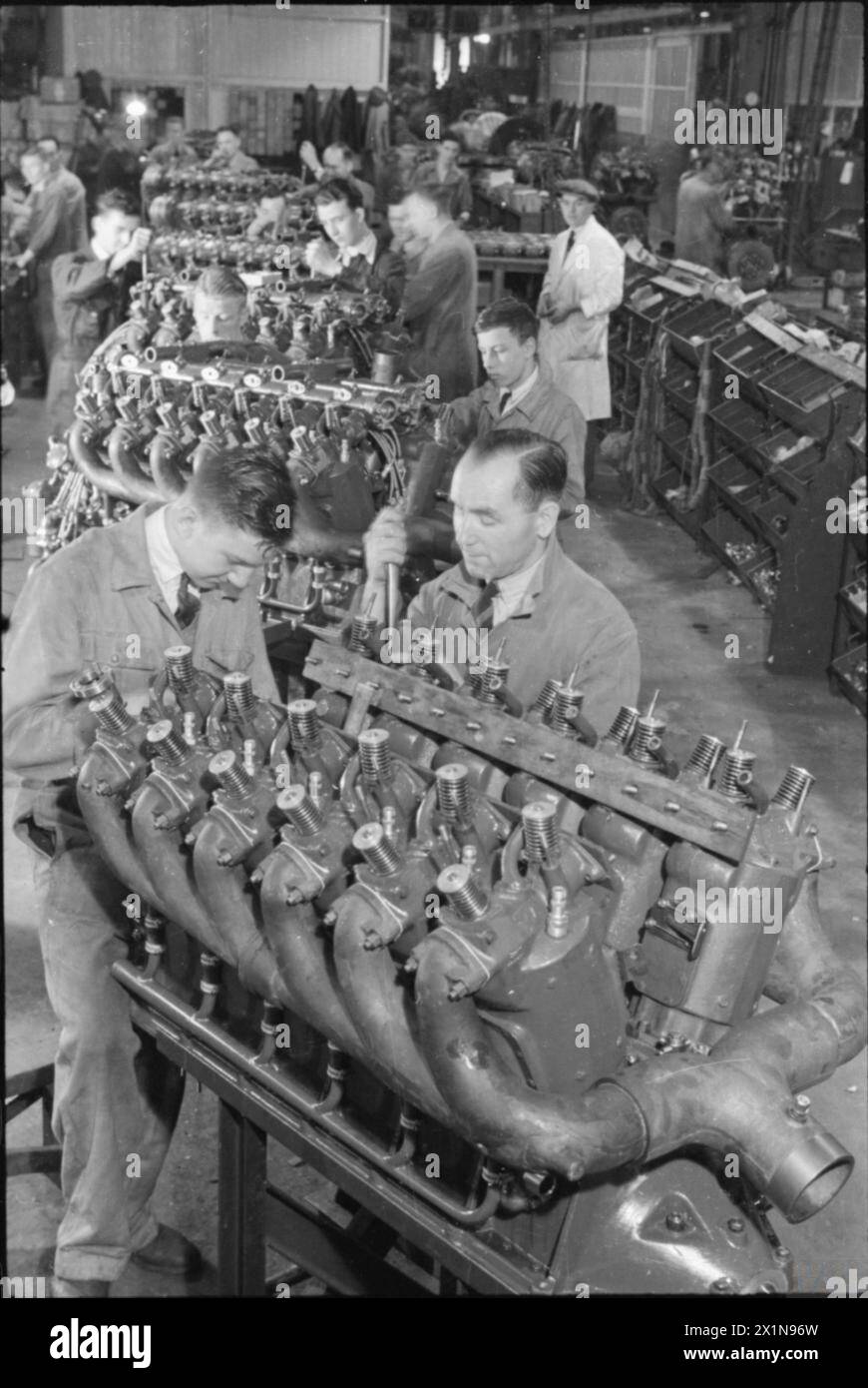 Workers assemble the final components of a Crusader tank engine at a ...