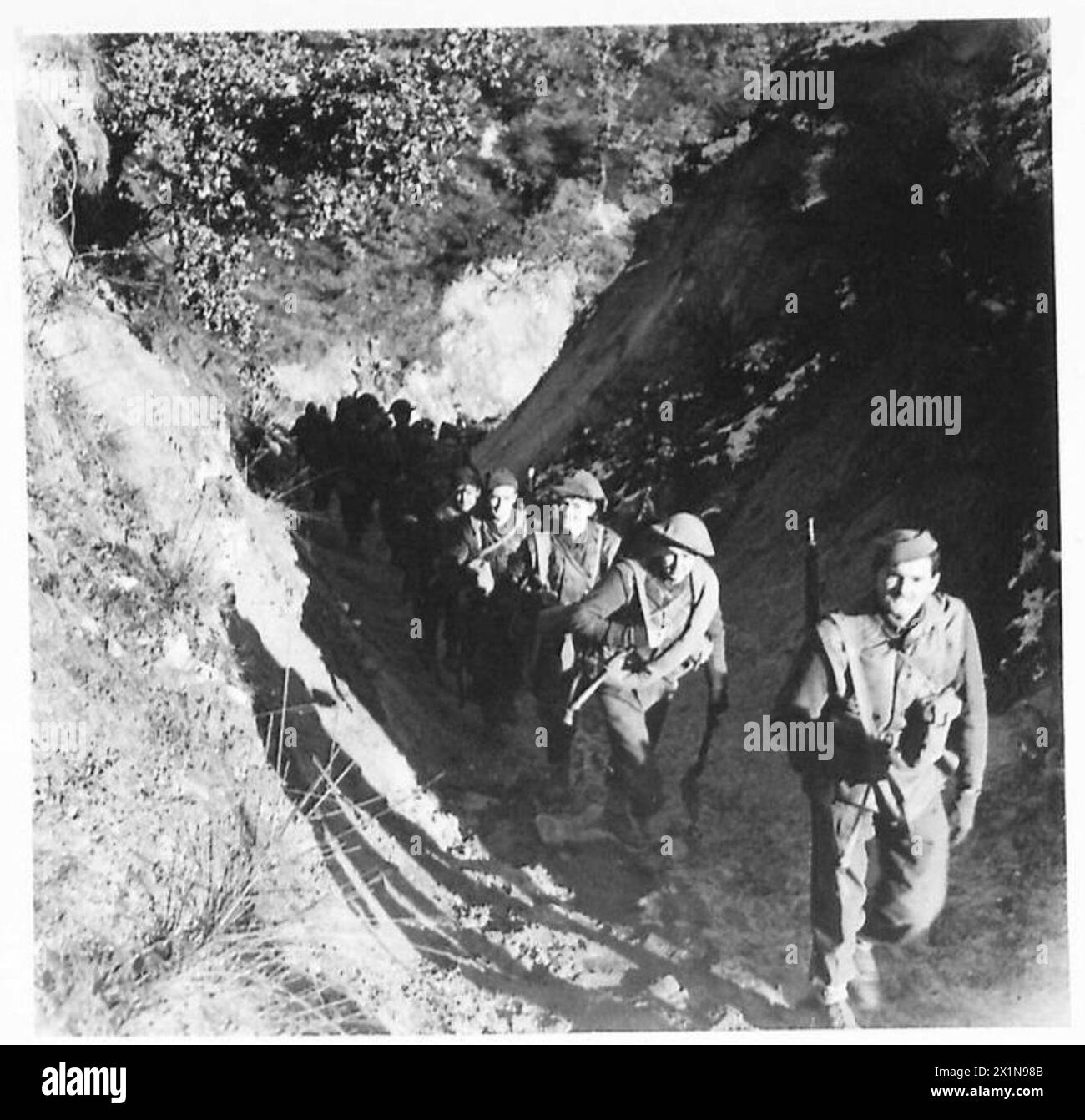 Fifth Army Guardsmen ascend a steep ridge to reach forward positions ...