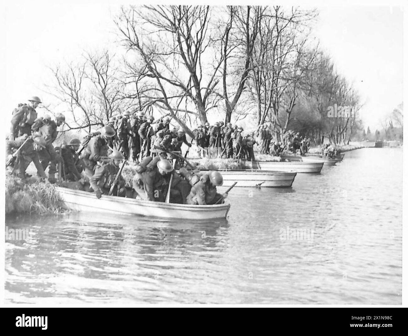 British Army troops launch boats to cross a river during a field ...