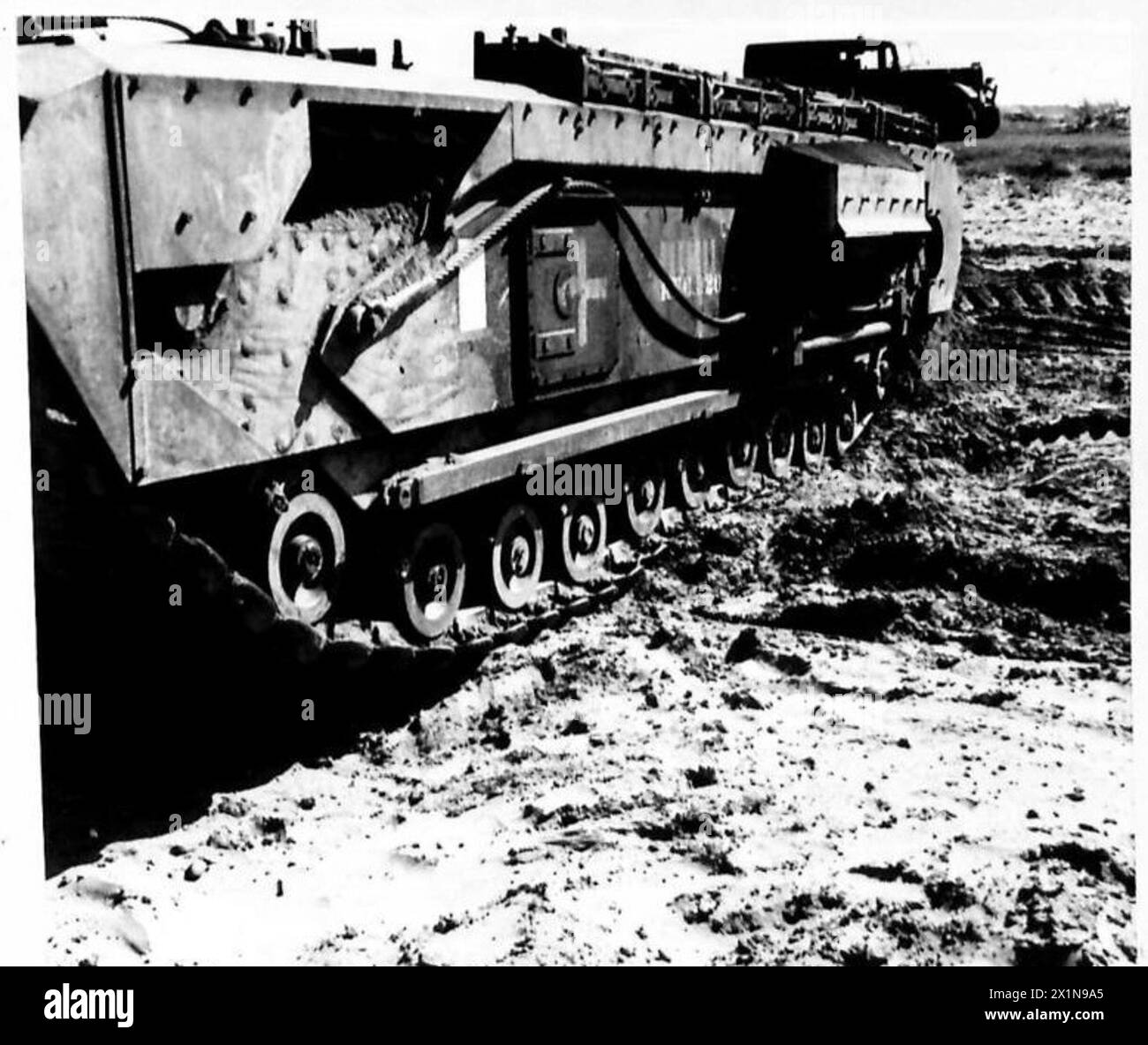 Experiments in tank recovery show Churchill tanks with shingle plates ...