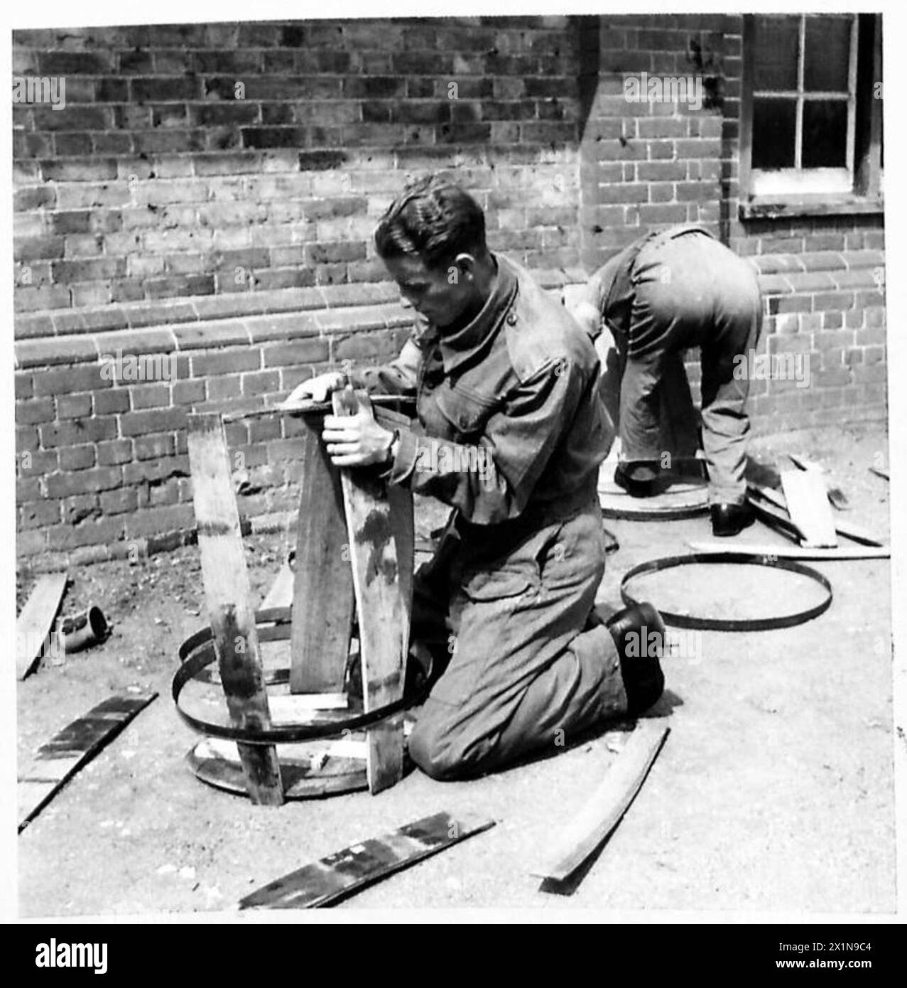 Candidates undergo a barrel making test at the War Office Selection ...