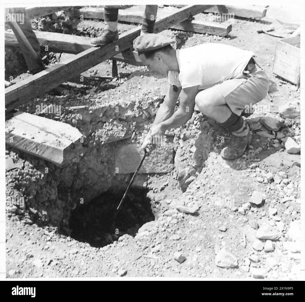 Men of a Bomb Disposal Squad inspect for unexploded bombs along railway ...