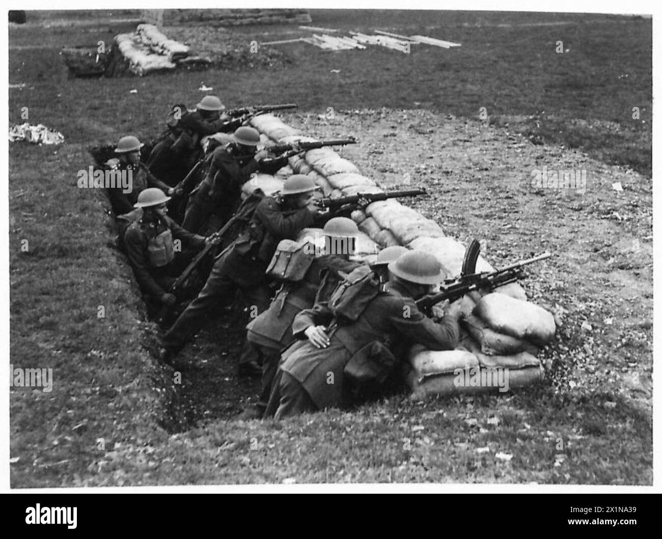 Infantry soldiers conduct rifle and Bren gun training from covered ...