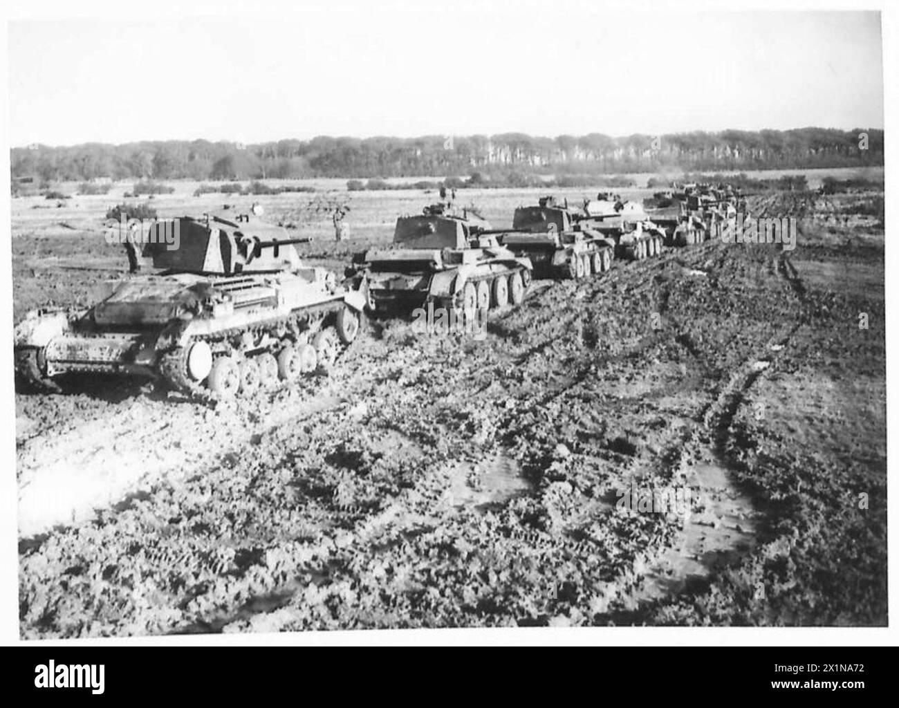 Cruiser tanks of the Royal Armoured Corps fire broadside while moving ...