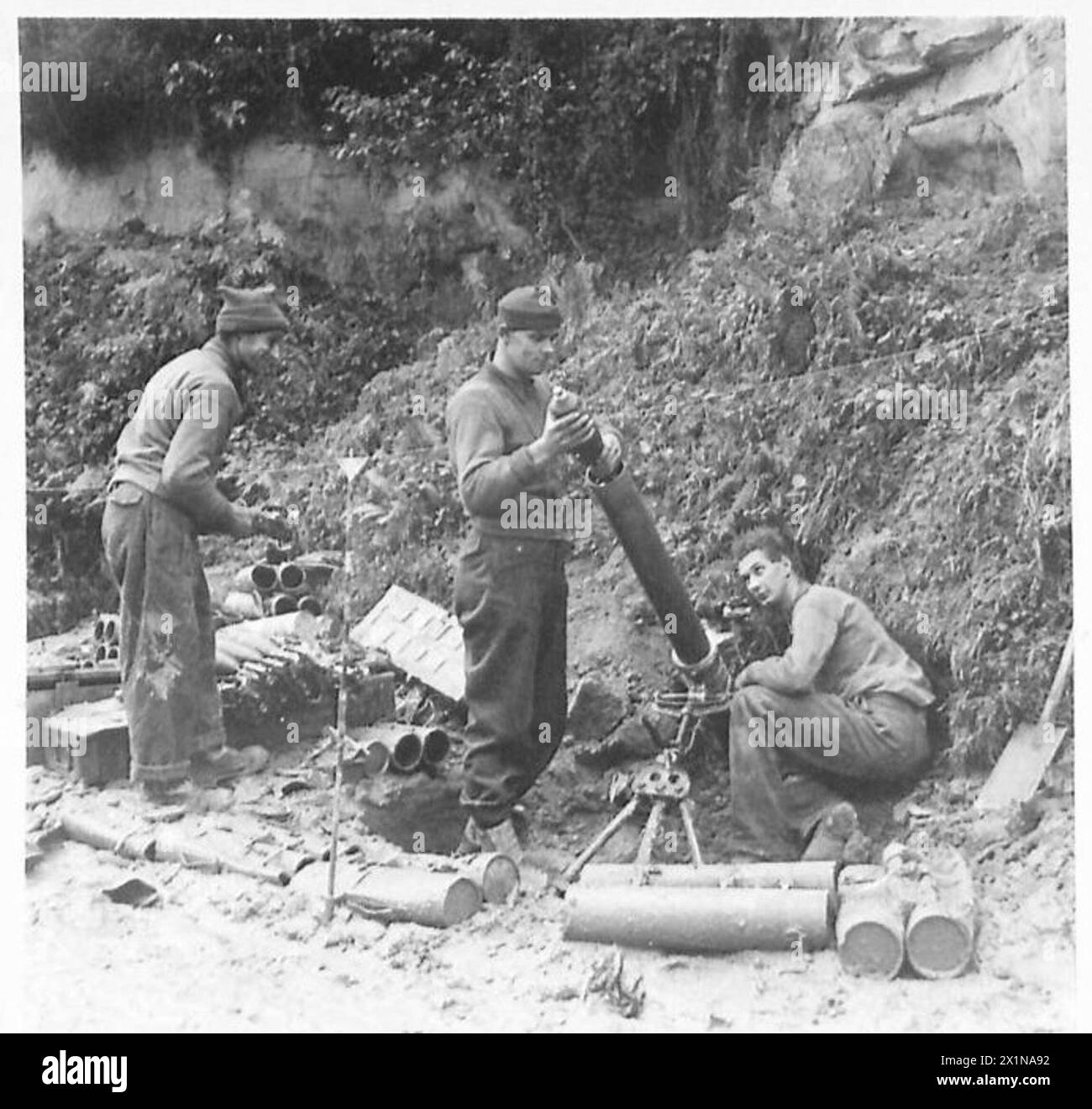 A British soldier loads a 4.2-inch mortar during Fifth Army operations ...